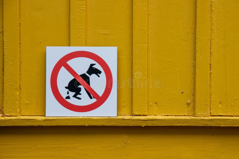Sign Prohibiting Dogs on a Yellow Wall Stock Image - Image of wall ...