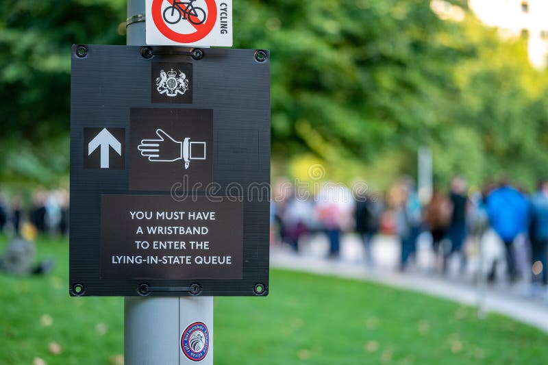A Sign for the Queen S Lying in State with a Large Queue of People in ... A Sign for the Queen S Lying in State with a Large Queue of People in ...