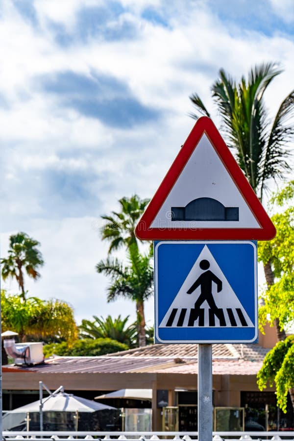 A Sign with a Red Triangle and a Blue Crosswalk Symbol Stock Image ...