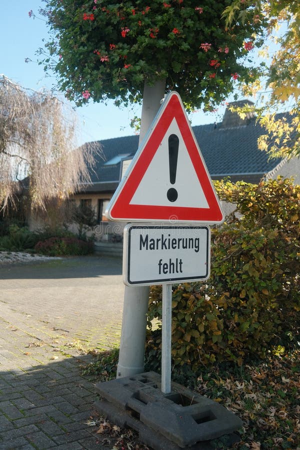 A Sign with a Red and White Triangle and the Word Markierung on it ...