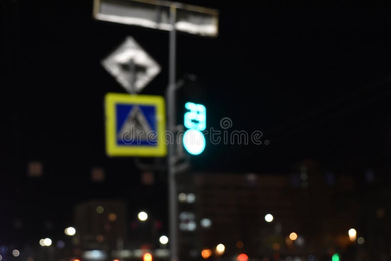 The Sign of the Road Crossing and the Lights of the Night City Stock ...