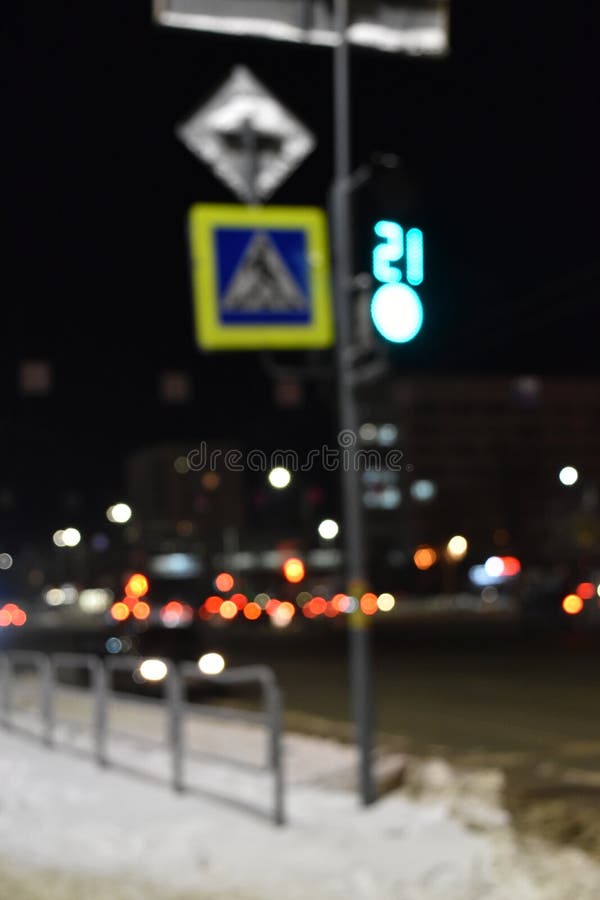 The Sign of the Road Crossing and the Lights of the Night City Stock ...