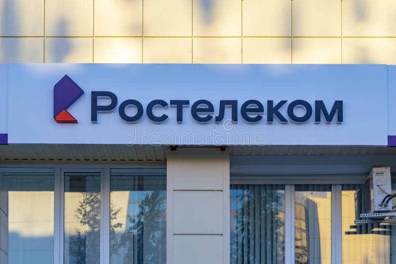 Sign in Russian `Rostelecom` on the Facade of the Building. Front View ...