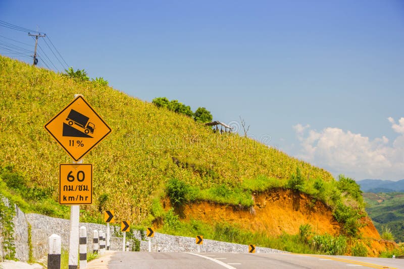 Sign Showing the Way Down the Slope on Road Stock Image - Image of hill ...