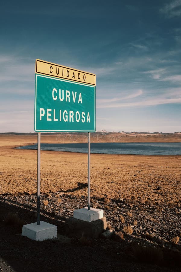 Sign in Spanish: Dangerous Bend in a Desert Landscape in Peru. Stock ...