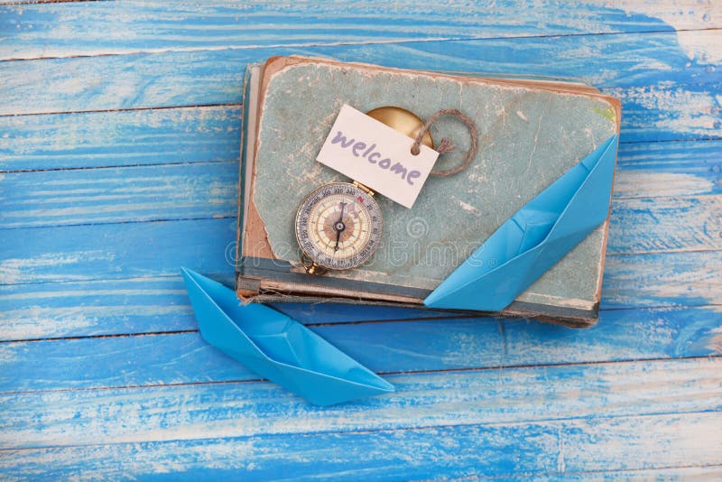 Sign Welcome and Compass on Old Book - Vintage Style Stock Photo ...