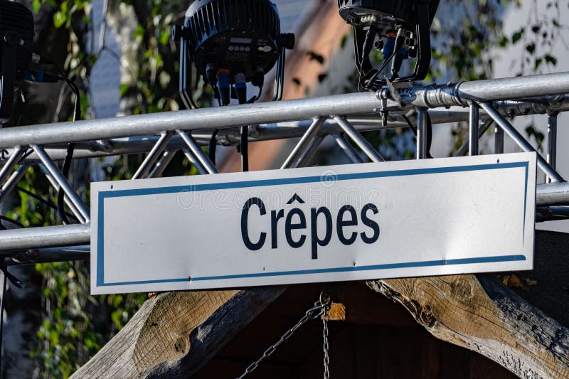 A Sign with the Word Crepes Written on it Stock Image - Image of street ...