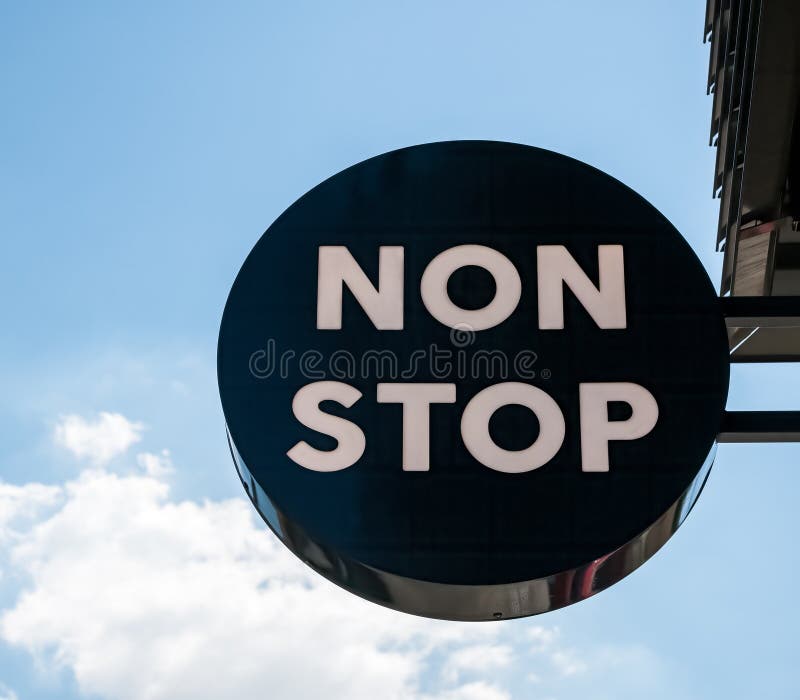 Sign with the Word NON-STOP Written with White Letters on Black Stock ...