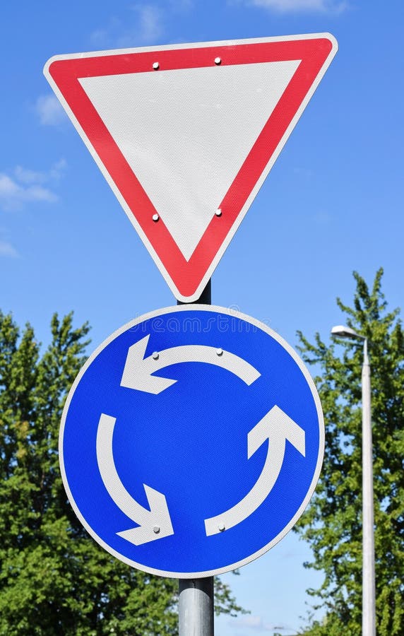 Poteau De Signalisation De Rendement Et Signe De Rond Point Photo stock ...