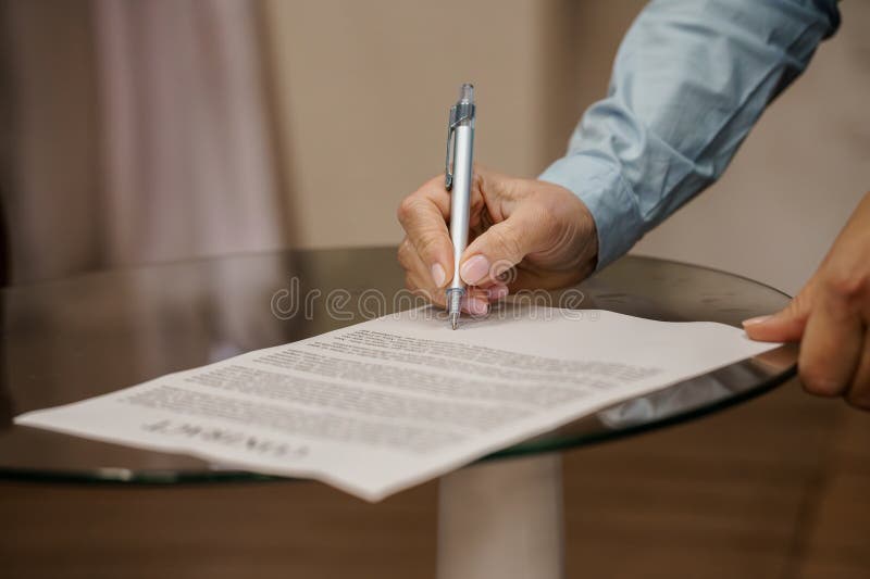 Signing a Formal Document with a Pen on a Glass Table Stock Photo ...