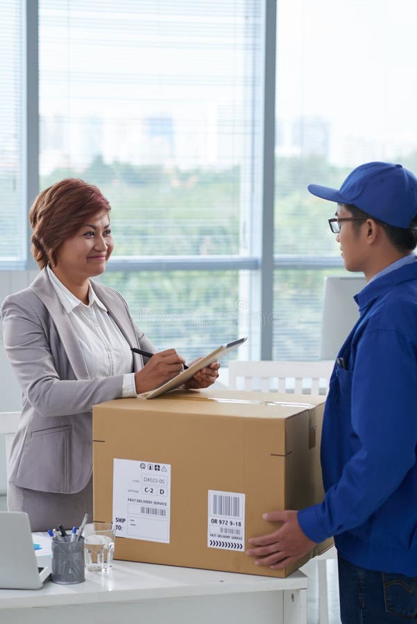 Signing parcel documents stock image. Image of shipment - 127950635