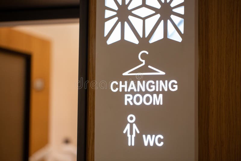 Signs for "Changing Room" and Male WC on the Wall Stock Photo - Image ...