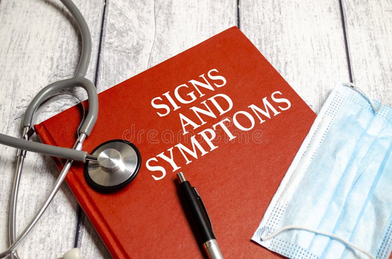 Signs and Symptoms Words on with Sticker Near Red Notebook with ...