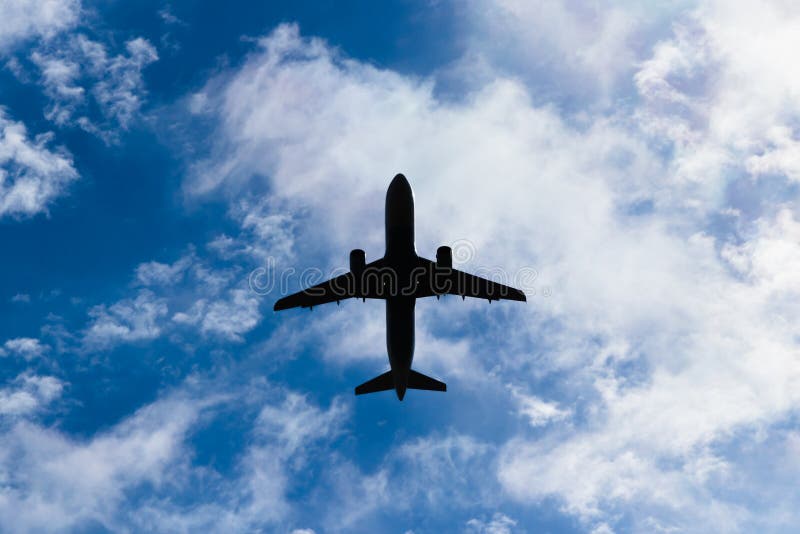 Silhouette of the Aircraft Against the Cloudy Sky. Bottom View. Stock ...