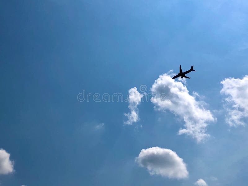 Silhouette of an Airplane Flying in the Blue Sky Stock Image - Image of ...