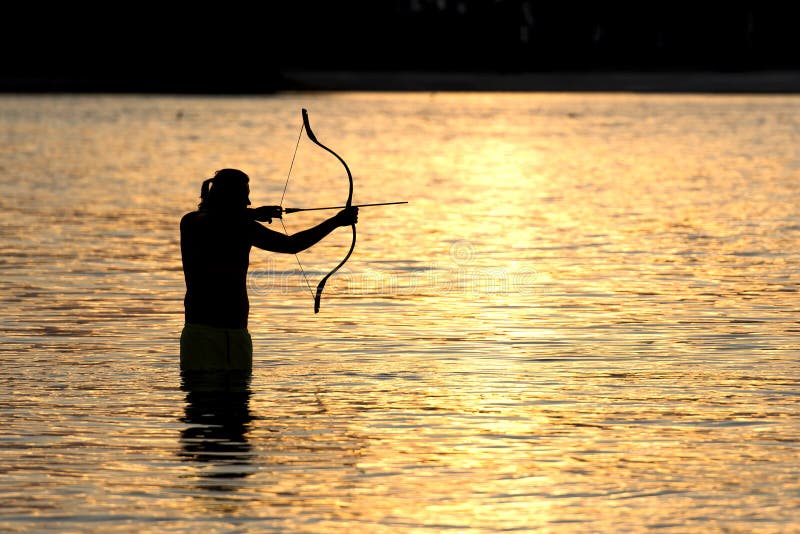 Silhouette Archery Shoots a Bow at a Target in Sunset Sky Stock Photo ...