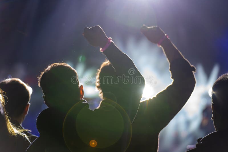 Crowded Concert with Uplifted Hands Against a Sunset Sky Stock Image ...
