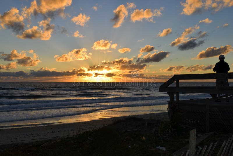 Silhouette on Beach Deck at Sundown Stock Image - Image of sunset ...