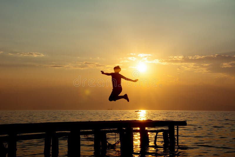 Silhouette of a Boy Jumping in the Sun Stock Photo - Image of father ...
