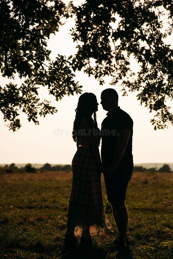 Silhouette of Beautiful Couple on the Sunset Stock Image - Image of ...