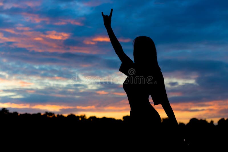 Silhouette of Beautiful Woman on the Background of Sunset Stock Photo ...