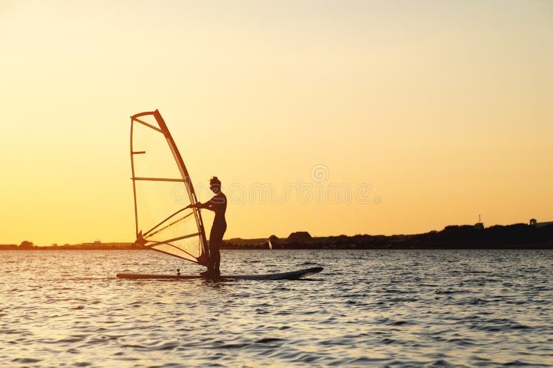 Silhouette of a Beginner Woman Windsurfer at Sunset. Windsurfing ...