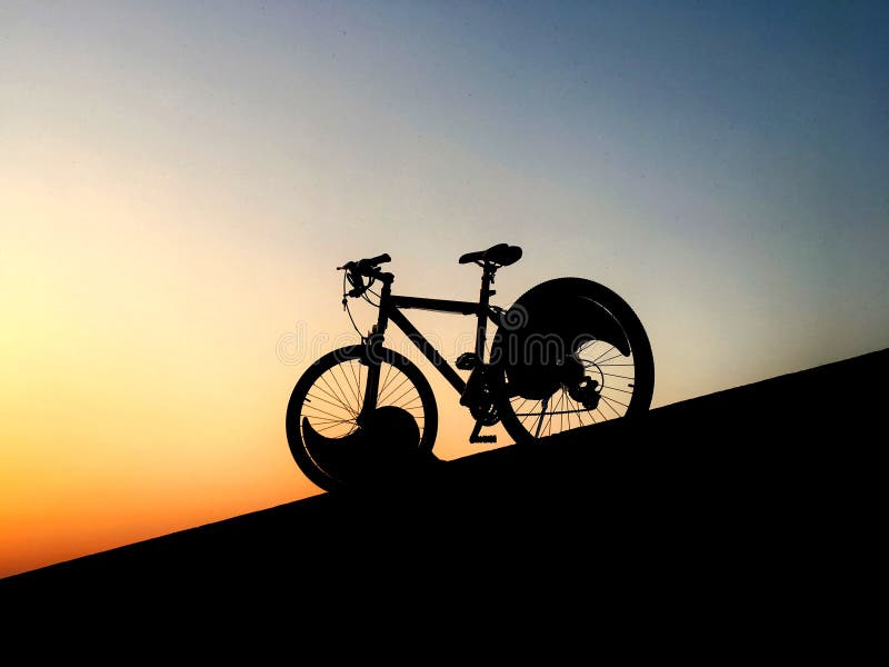 The Silhouette of the Bicycle Under the Sunset Stock Photo - Image of ...