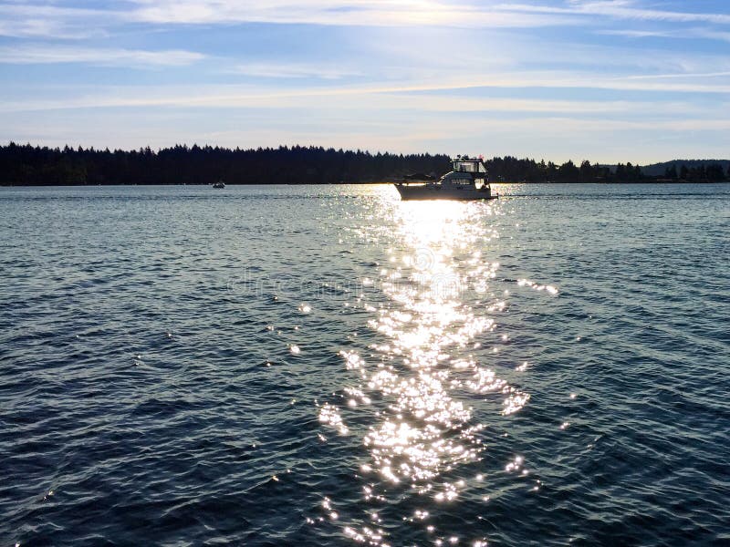 Silhouette of Boat on Water with Sun Reflection Stock Image - Image of ...