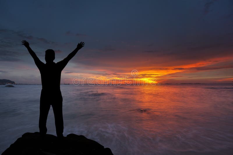 Silhouette of Boy with Hands Raised To Beautiful Sunset Stock Image ...