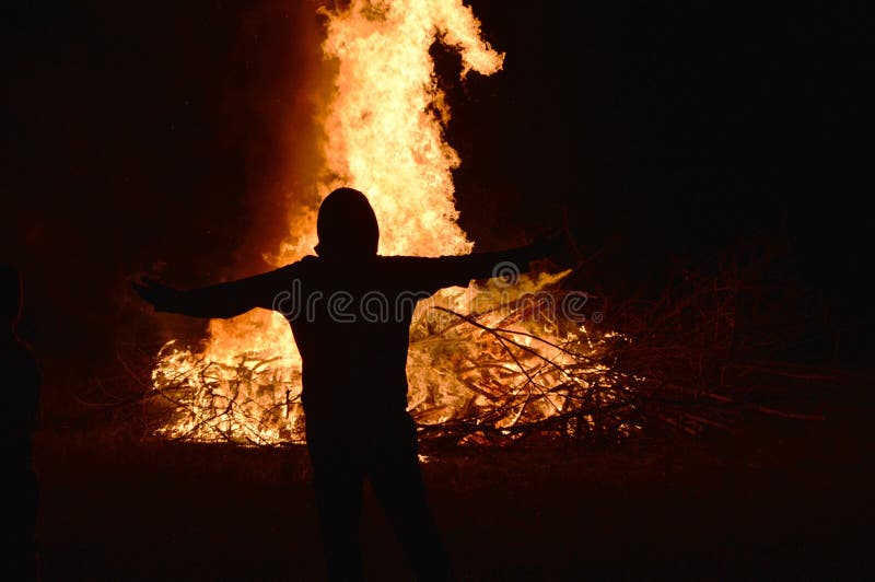 Silhouette of a Boy Hugging a Fire at Night Stock Photo - Image of ...