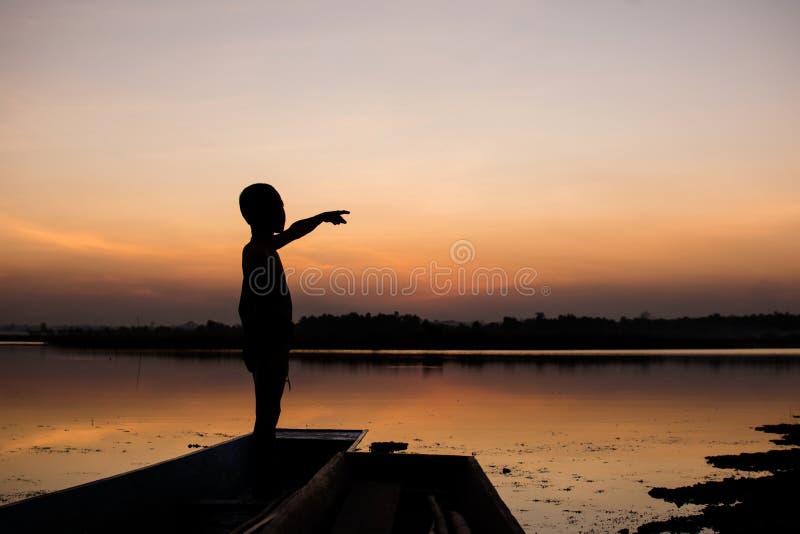 Silhouette of the Boy Stand Up Look the Sunset on the Boat. Stock Photo ...