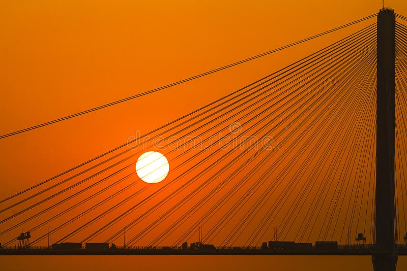 Silhouette of a Bridge Under Setting Sun Stock Image - Image of ...