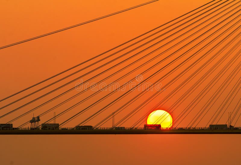 Silhouette of a Bridge Under Setting Sun Stock Image - Image of cross ...