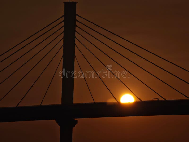 Silhouette of a Cable-stayed Bridge at Sunset, with the Sun Setting ...