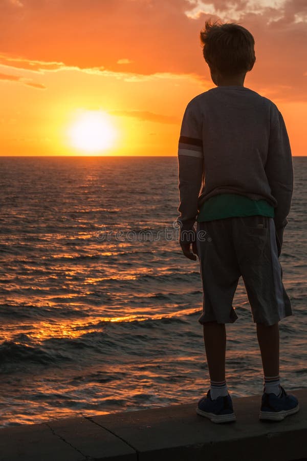 Silhouette of a Child in Front of Sea at Sunset Stock Photo - Image of ...