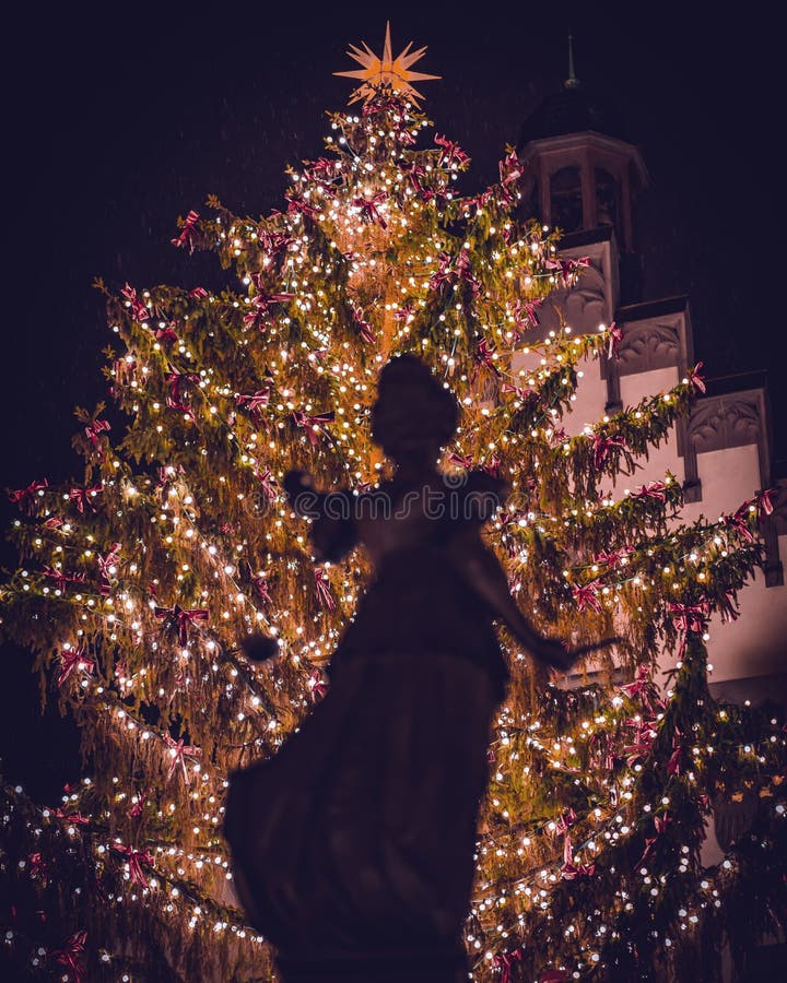 Silhouette of the Child Sculpture in Front of the Bright Christmas Tree ...