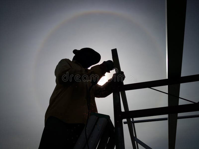 Silhouette of a Construction Worker Working Under Hot Sun Stock Photo ...