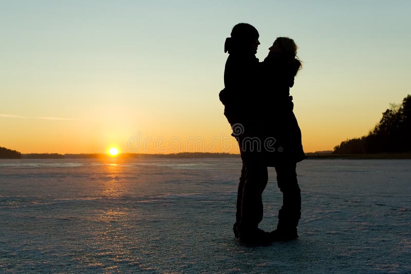 Silhouette of a Couple Hugging on Ice Stock Photo - Image of horizontal ...