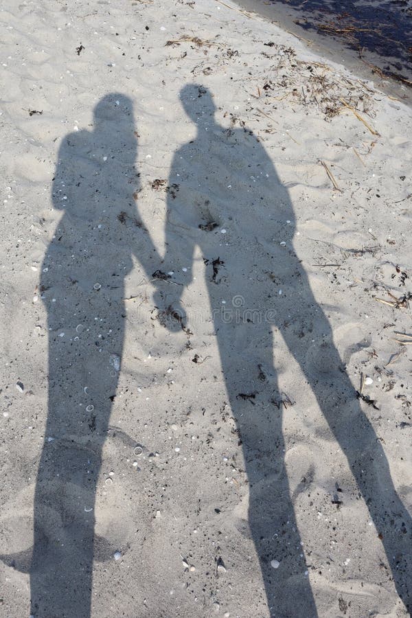 Couple shadow on beach stock image. Image of sand, beach - 327223145