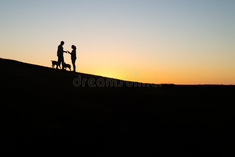 Silhouette of Couple Whit Two Dogs in a Hill at Sunset Stock Image ...
