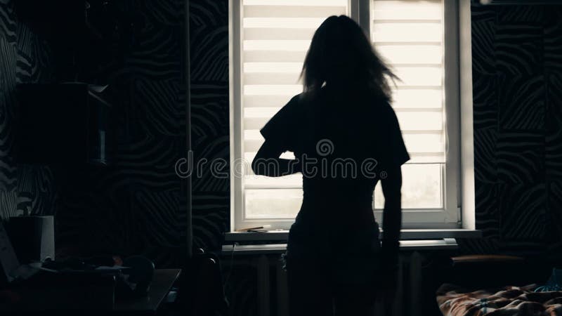 Silhouette of a Girl Dancing in Front of a Window at Home Stock Footage ...