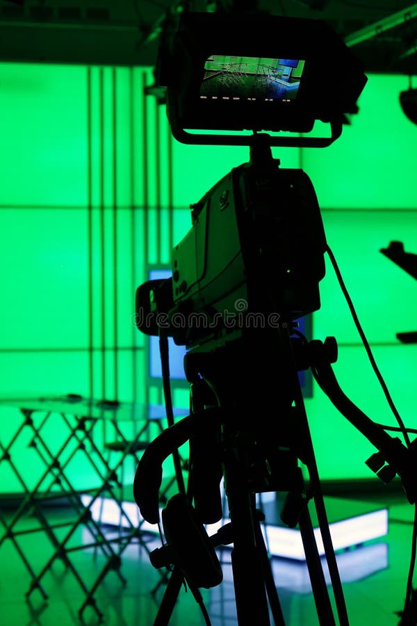 Silhouette of a Digital Video Camera in Front of a Green Screen. Stock ...
