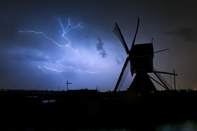 Windmill Silhouette with Powerful Lightning Bolts Streaking through the ...