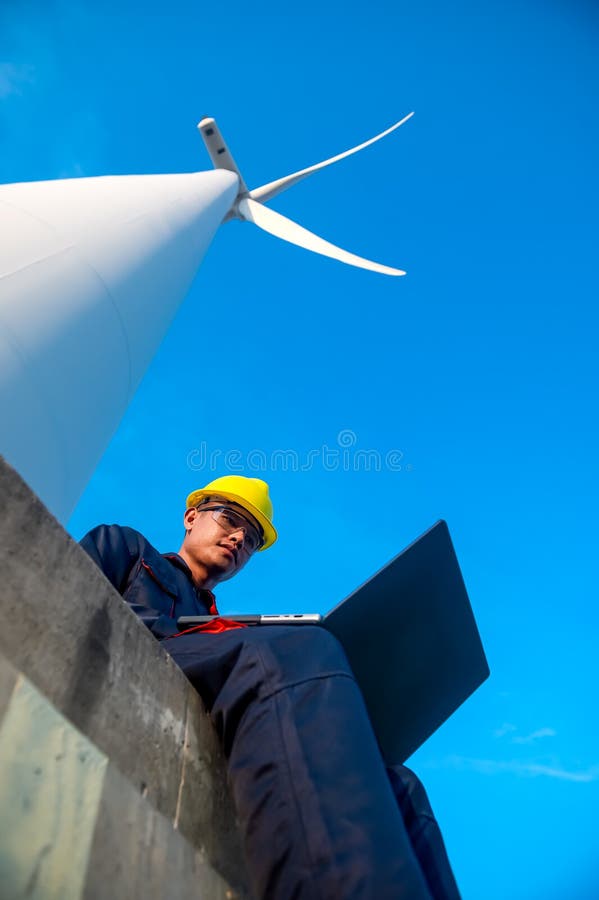 Silhouette of an Engineer Working Under a Wind Turbine Tower Stock ...