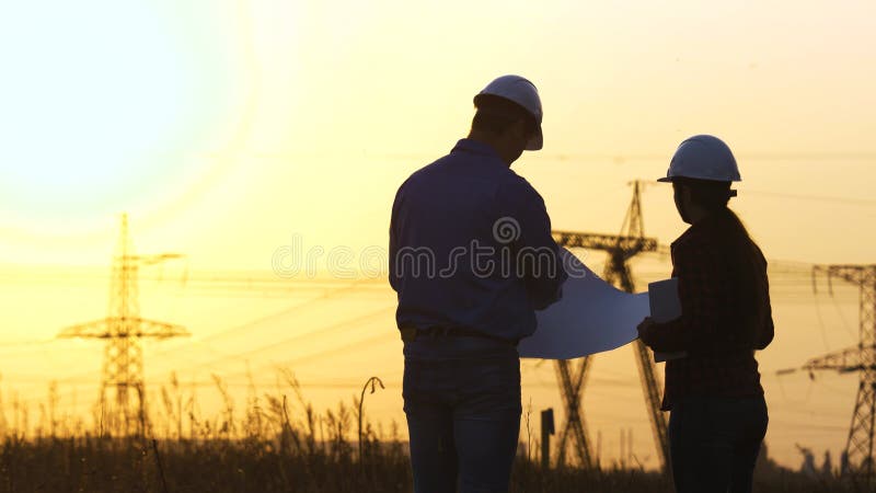 Silhouette of Engineers Looks at the Construction of High-voltage Power ...