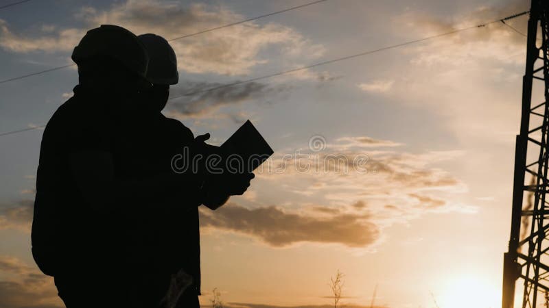 Silhouette of Engineers Looks at the Construction of High-voltage Power ...