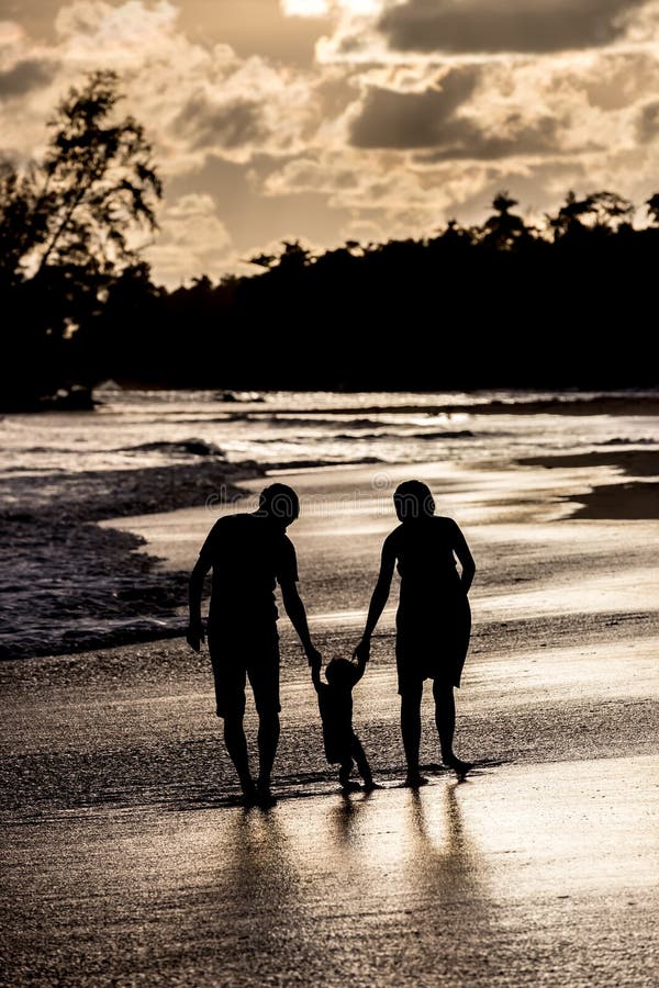 Silhouette of Family on the Beach at Sunset Stock Photo - Image of ...