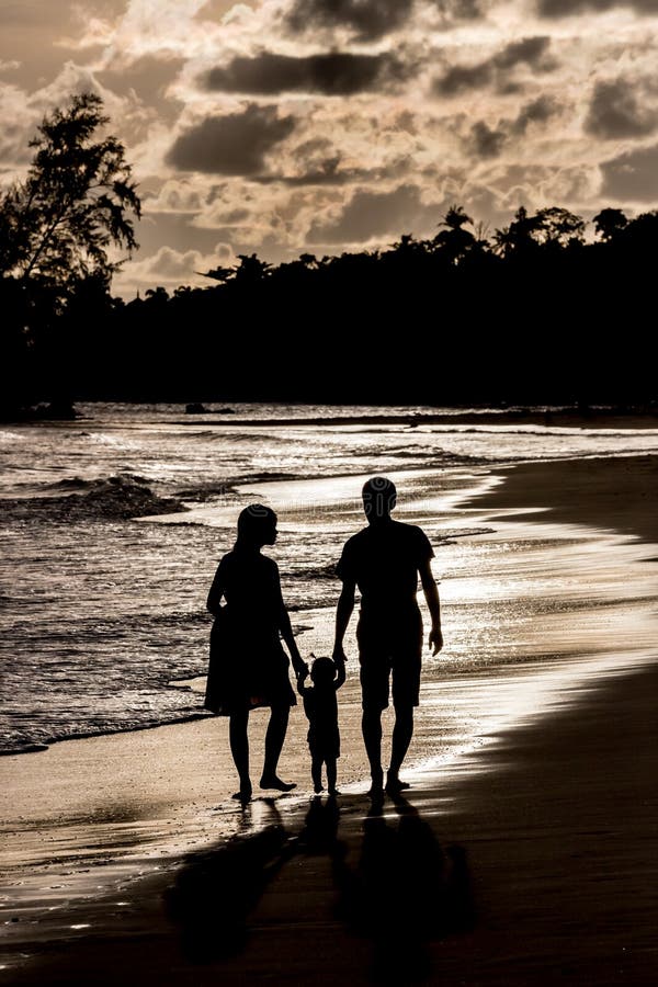 Silhouette of Family on the Beach at Sunset Stock Photo - Image of ...