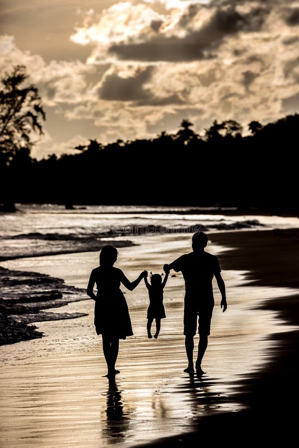 Silhouette of Family on the Beach at Sunset Stock Image - Image of ...