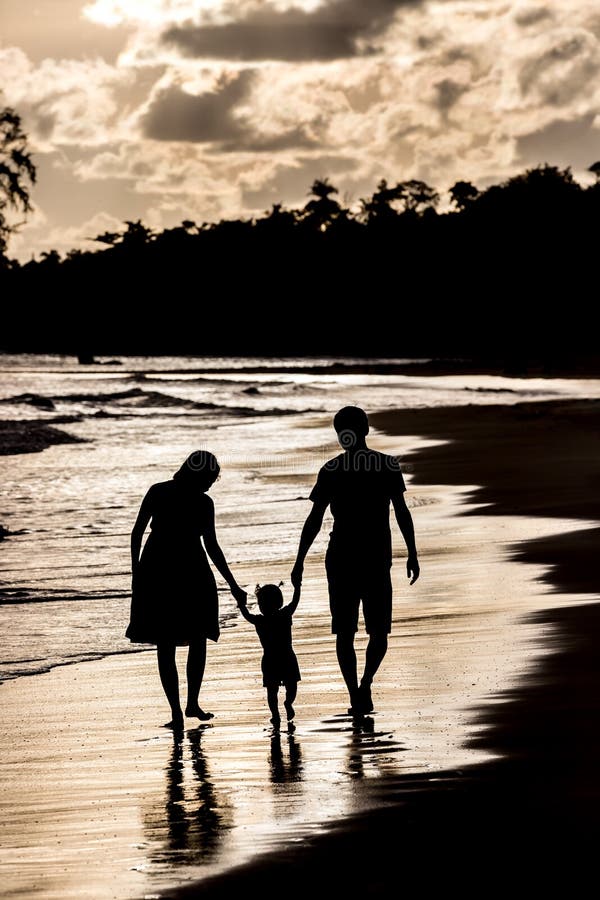 Silhouette of Family on the Beach at Sunset Stock Image - Image of male ...